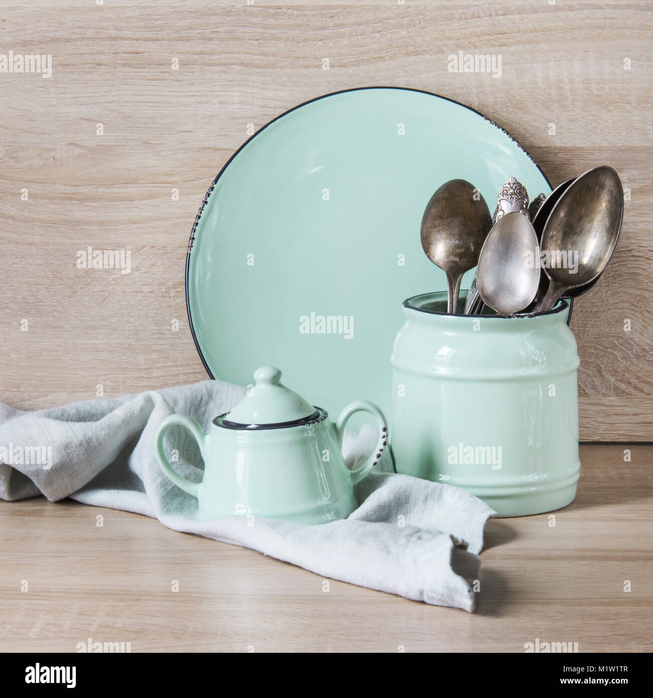 Turquoise crockery, tableware, dishware utensils and stuff on wooden ...