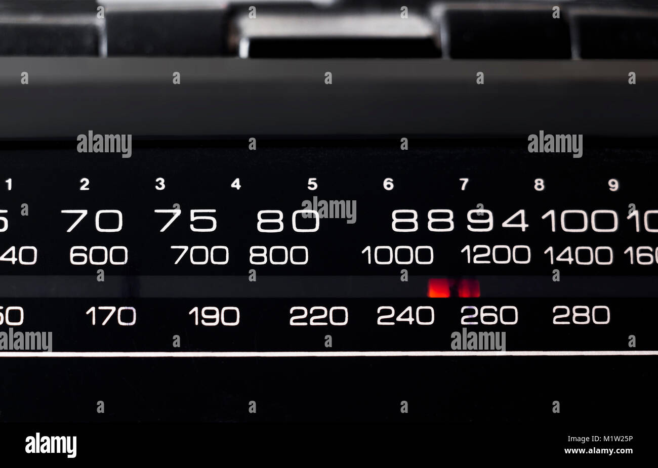 Black dial and red arrow of a portable radio close-up Stock Photo - Alamy