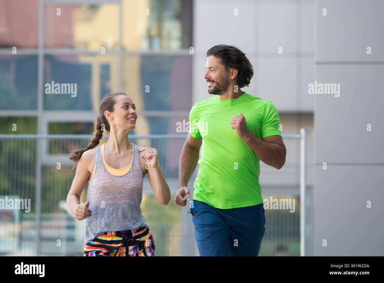 Couple running in urban enviroment at hot summer day Stock Photo - Alamy