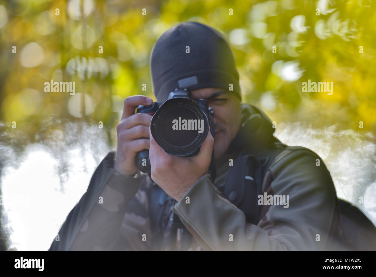 Wildlife, nature man photographer in camouflage outfit shooting, taking ...