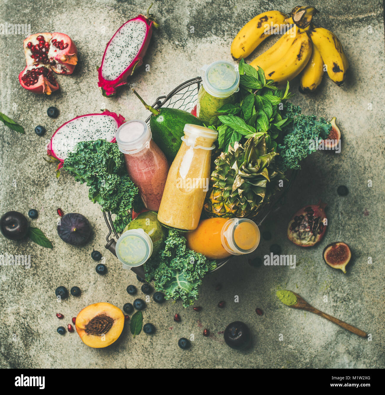 Colorful smoothies in bottles with fresh fruits in basket Stock Photo ...