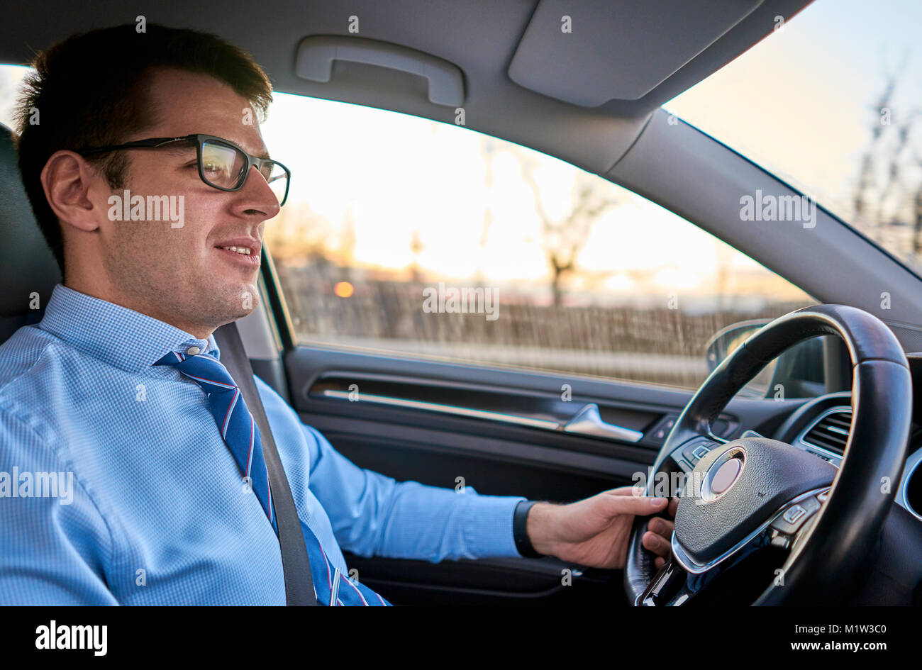 man in a shirt while driving Stock Photo - Alamy