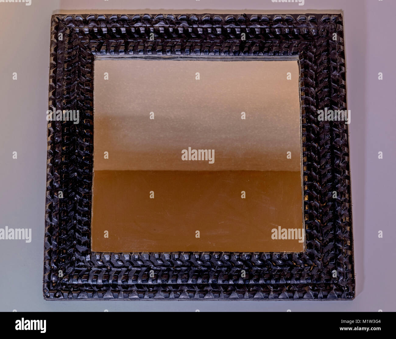 An unusual, square shaped novelty mirror, with the glass surround ...