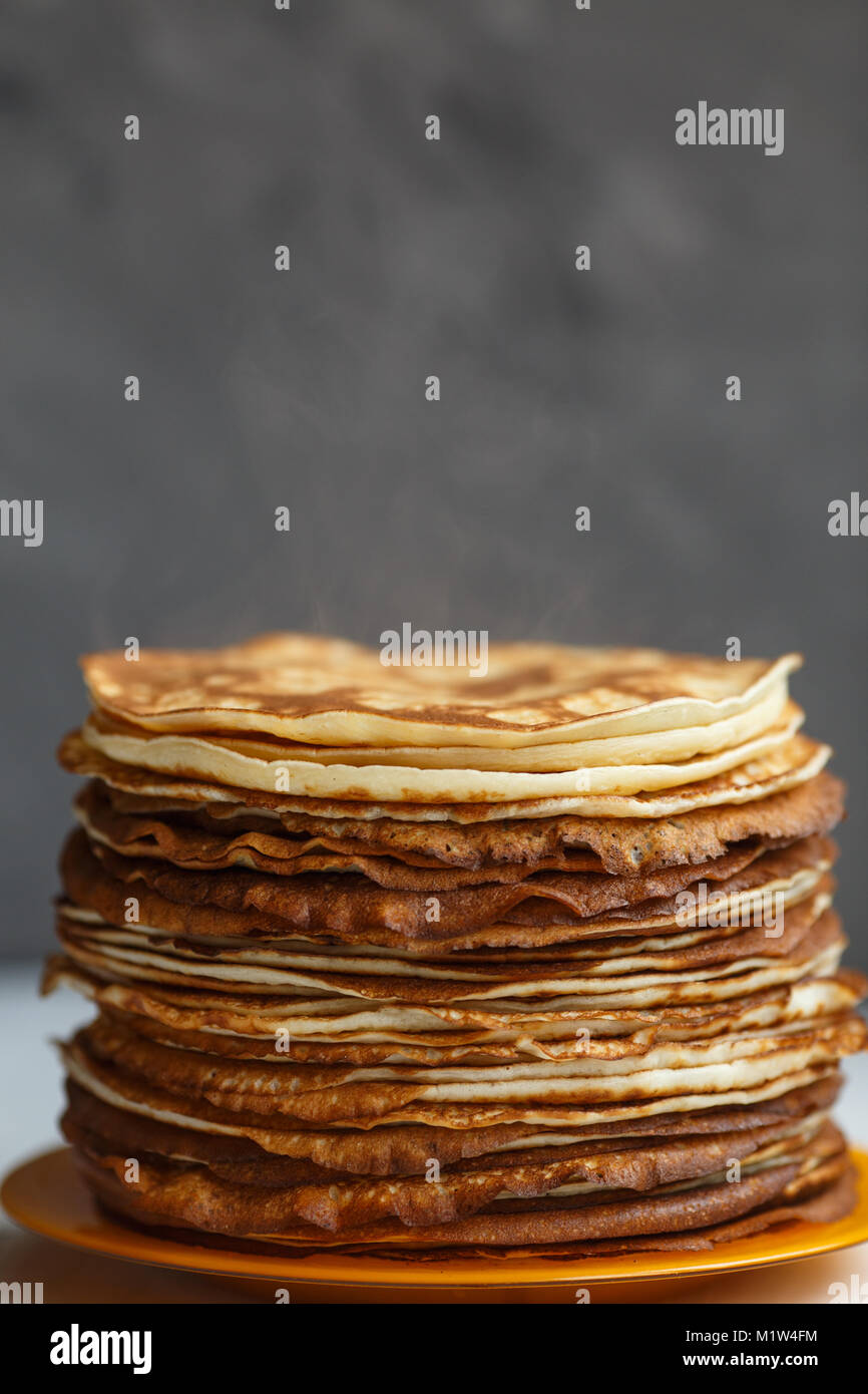 High stack of classic Russian thin pancakes. Rustic style. Traditional ...