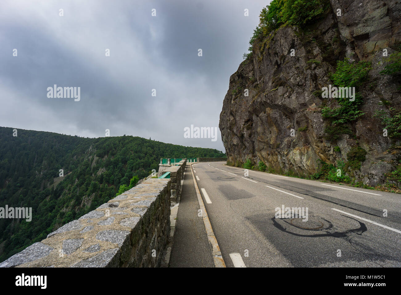 France - Curved street of route de cretes next to massive rocks in ...
