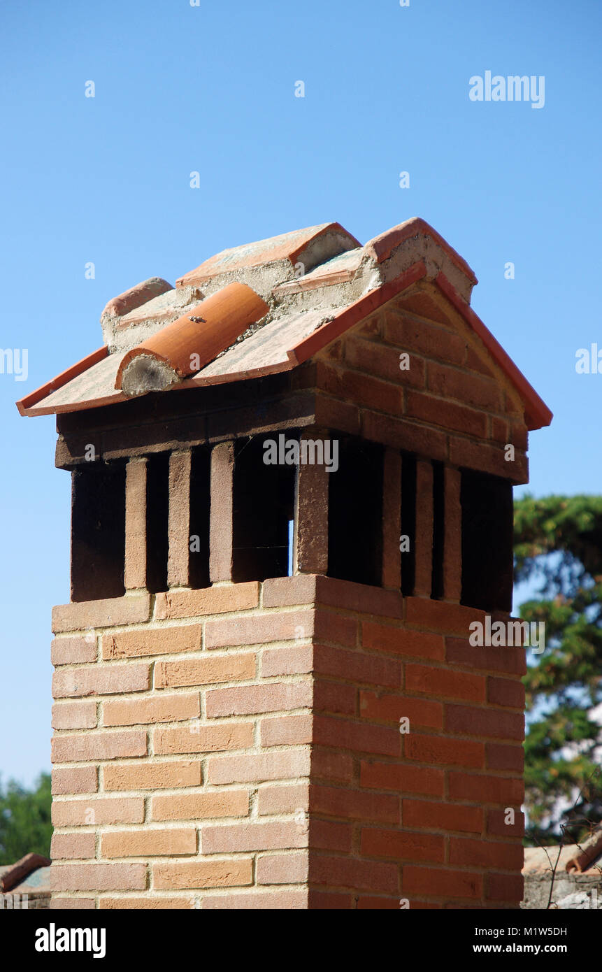 chimney built in bricks on the roof made of clay tiles Stock Photo - Alamy