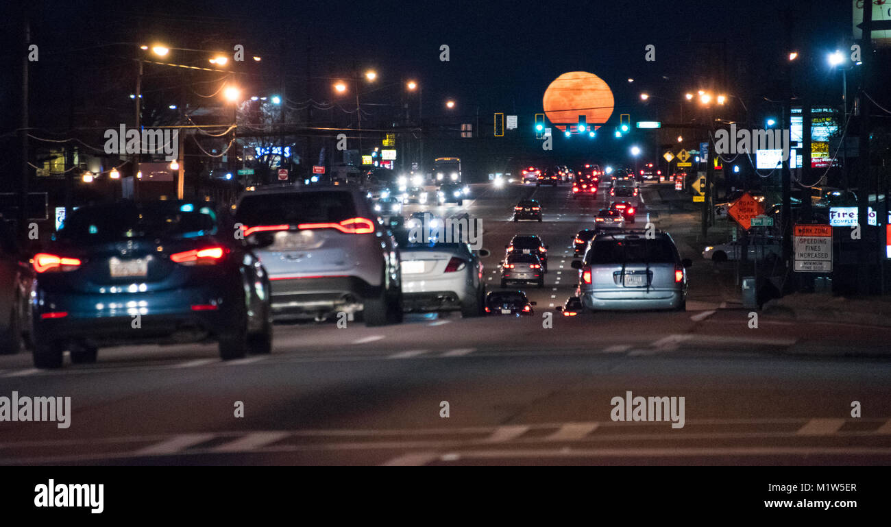 Metro Atlanta commuters in rush hour traffic as a full moon rises above ...