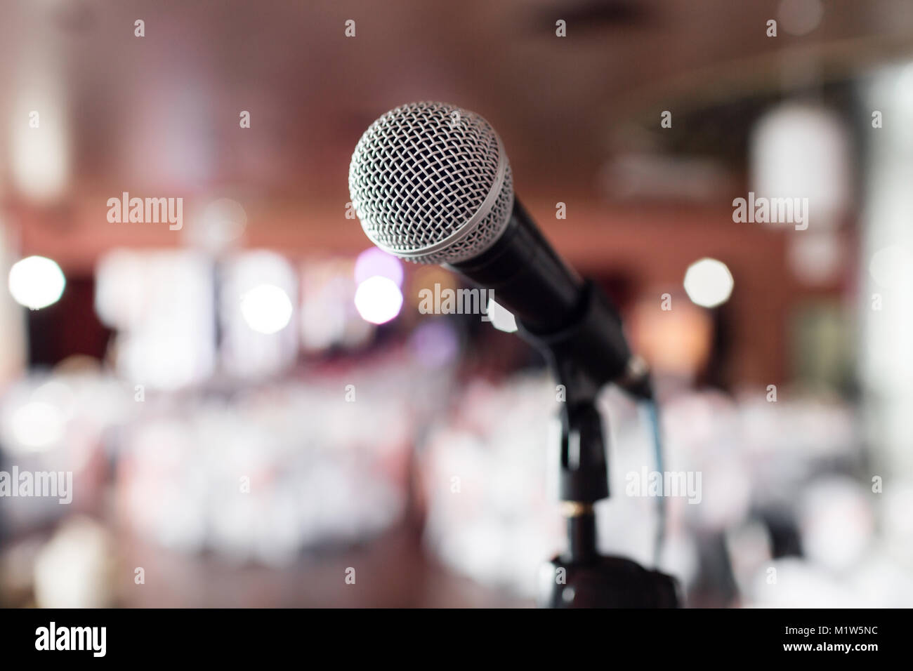 Microphone close-up. Focus on mic. Abstract blurred conference hall or ...