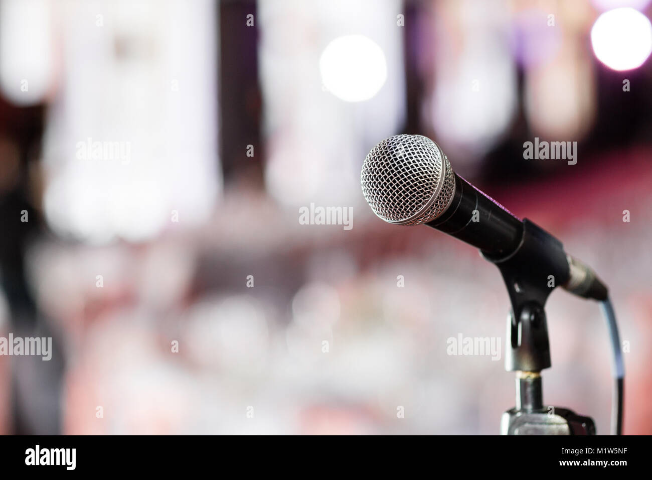 Microphone close-up. Focus on mic. Abstract blurred conference hall or ...
