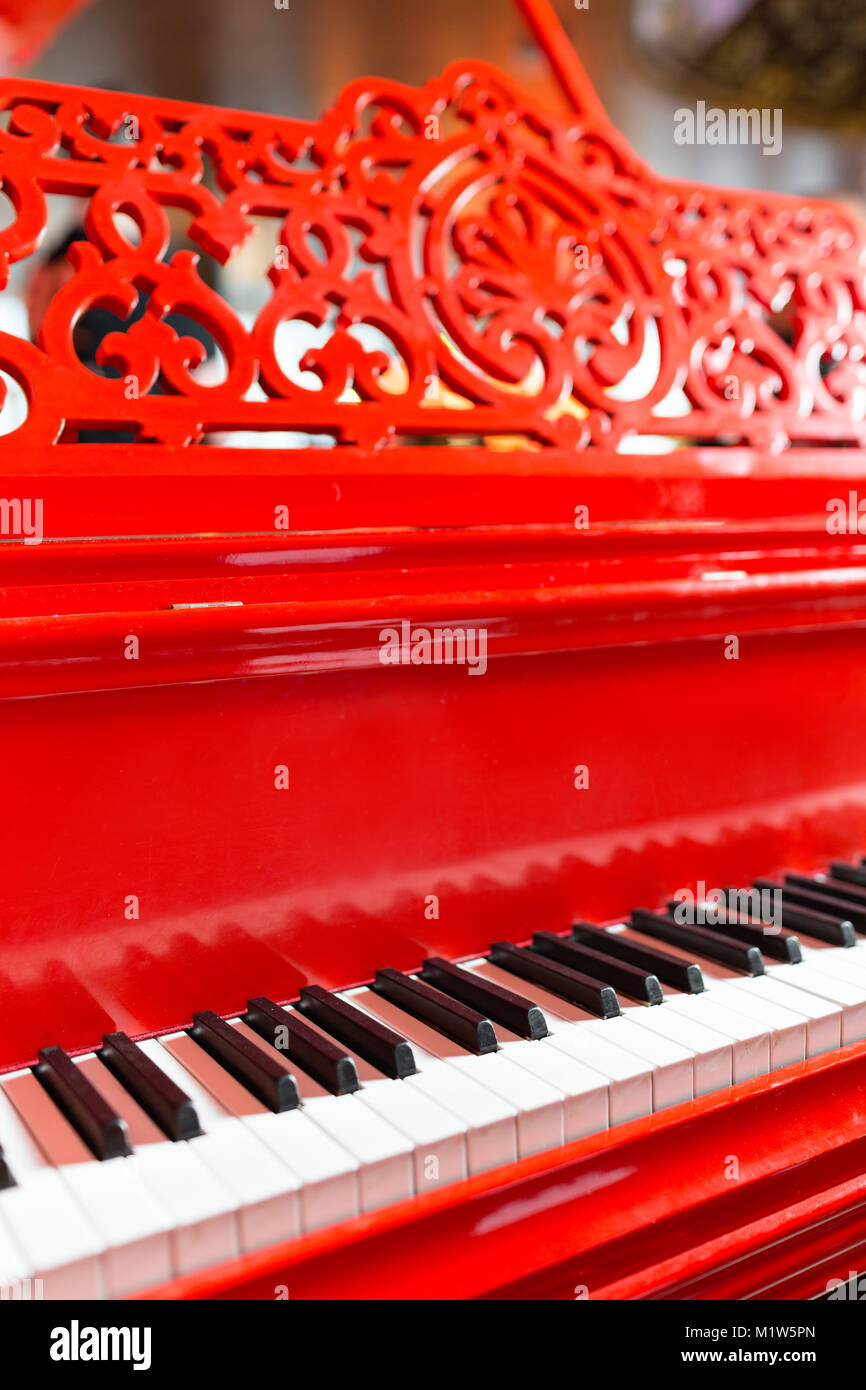 Vintage red classical grand piano. Black and white keys. Keyboard of ...