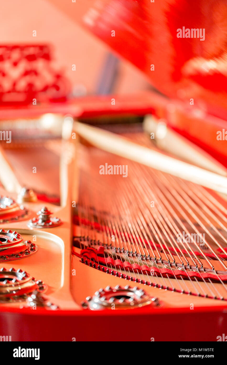 Strings close-up. Vintage red classical grand piano. Musical instrument ...
