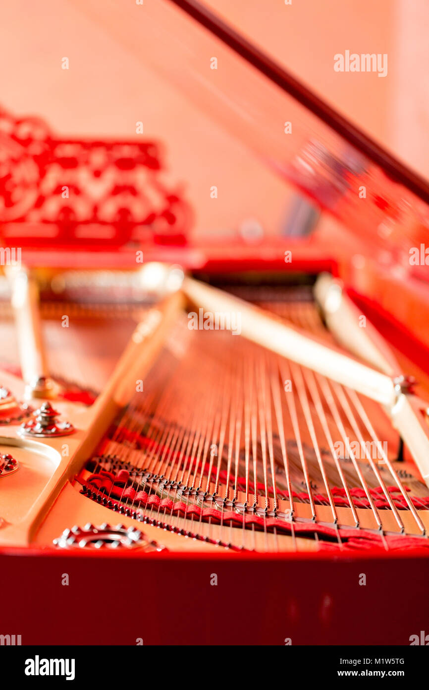 Strings close-up. Vintage red classical grand piano. Musical instrument ...