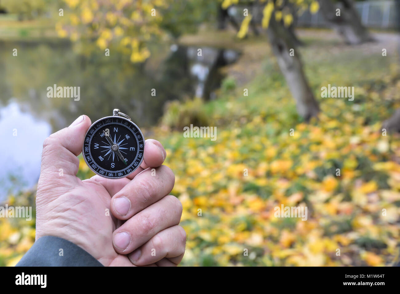 Compass in hand. Orientation on a walk with a navigation device Stock ...