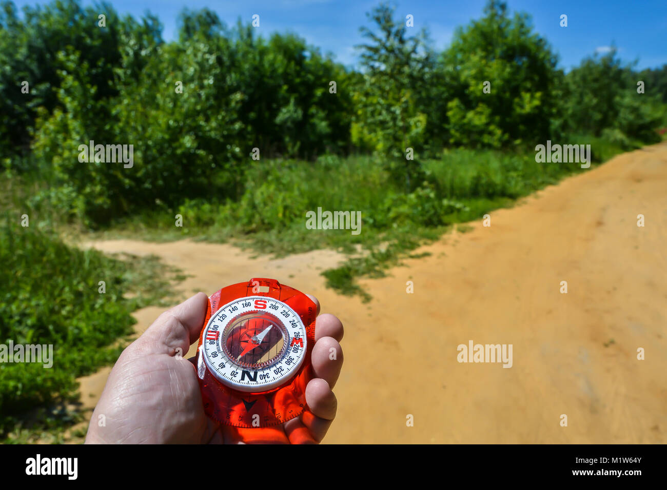 Compass in hand. Orientation on a walk with a navigation device Stock ...