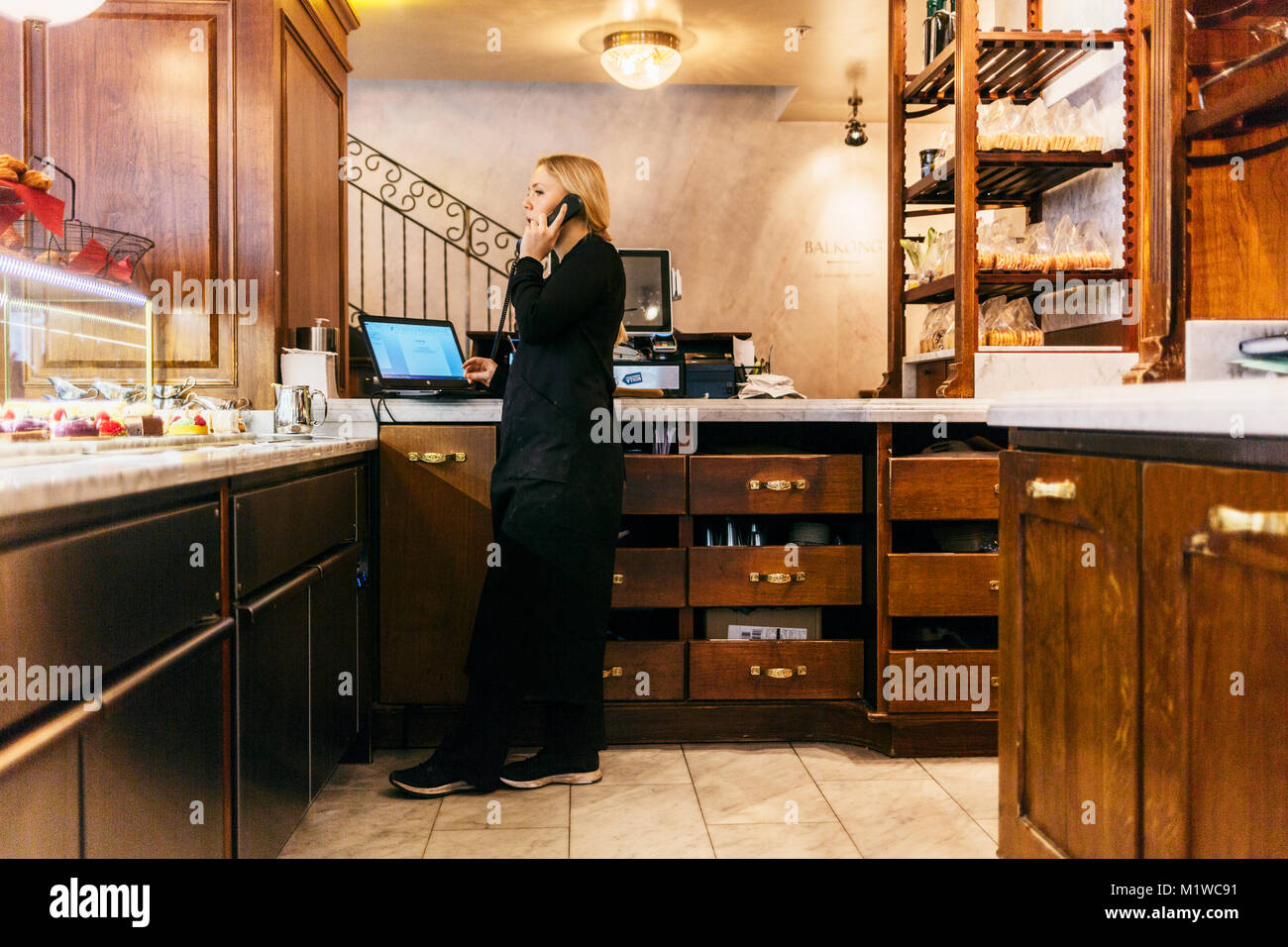 Woman on phone at bakery counter in Sweden Stock Photo - Alamy