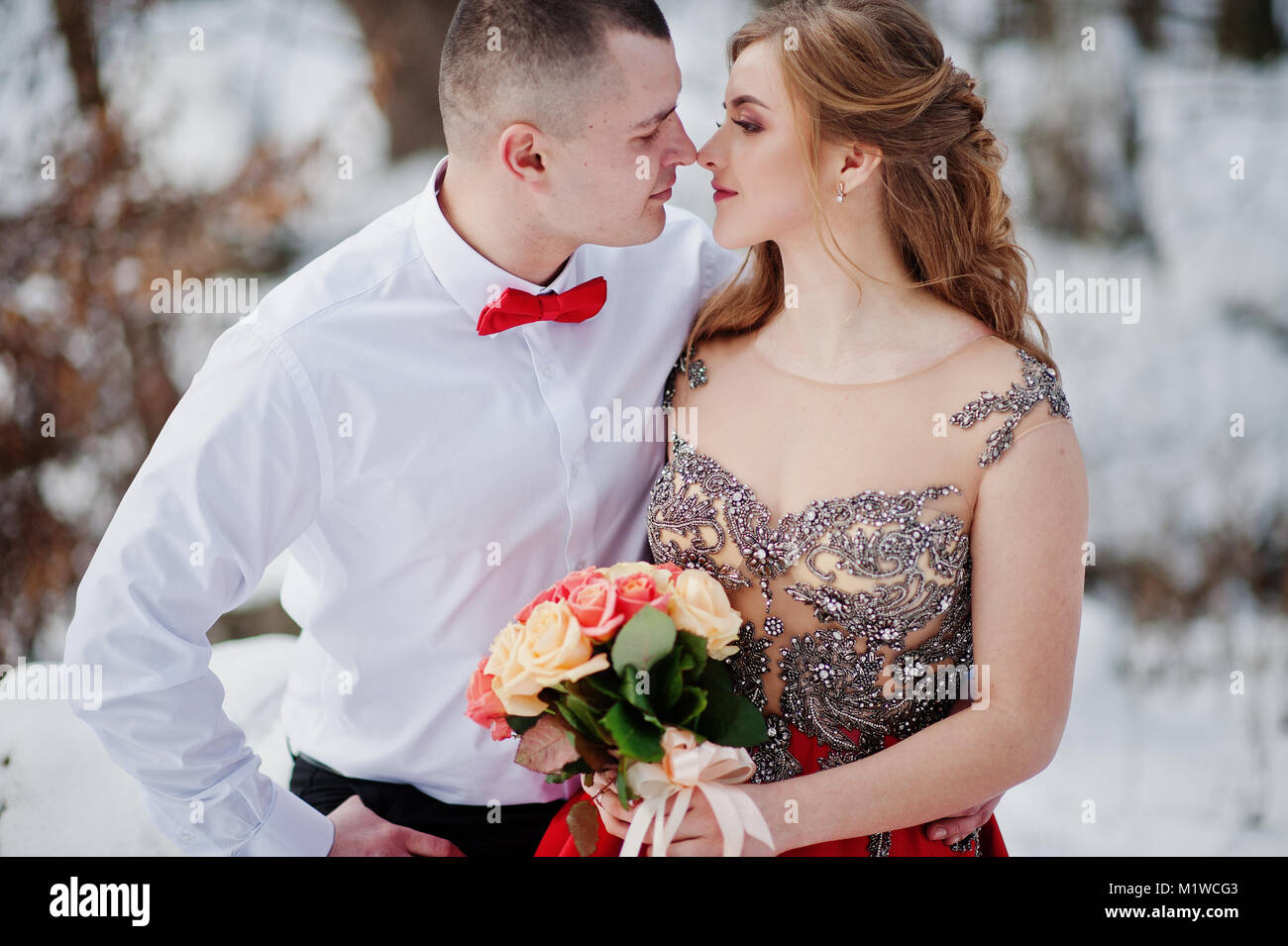 Amazing couple in winter fairytale forest in love. Girl in red ...