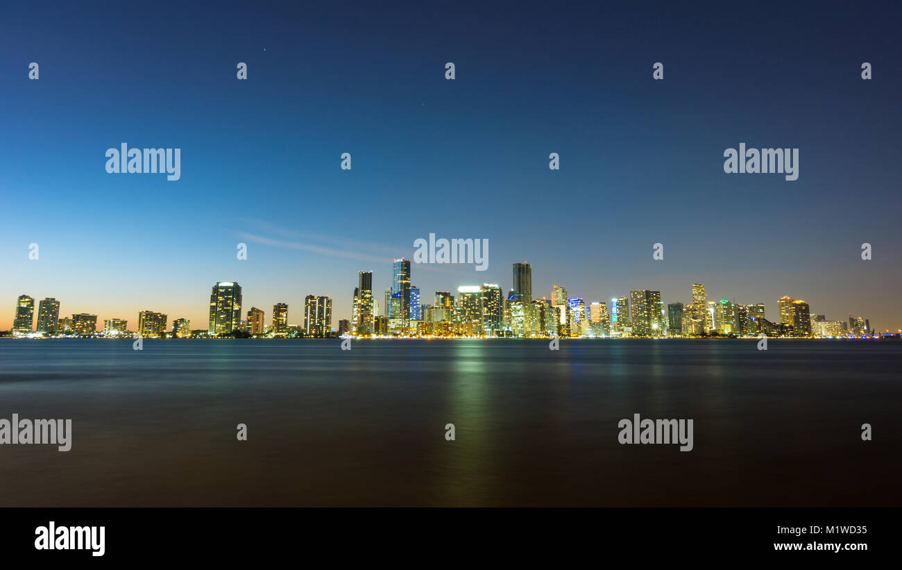 USA, Florida, Bright shining night skyline of miami with reflections on ...