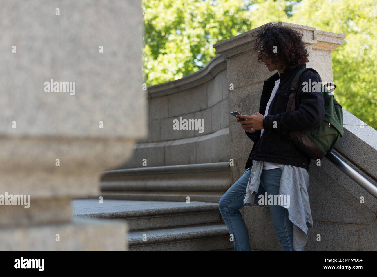 Man using mobile phone outside library building Stock Photo - Alamy