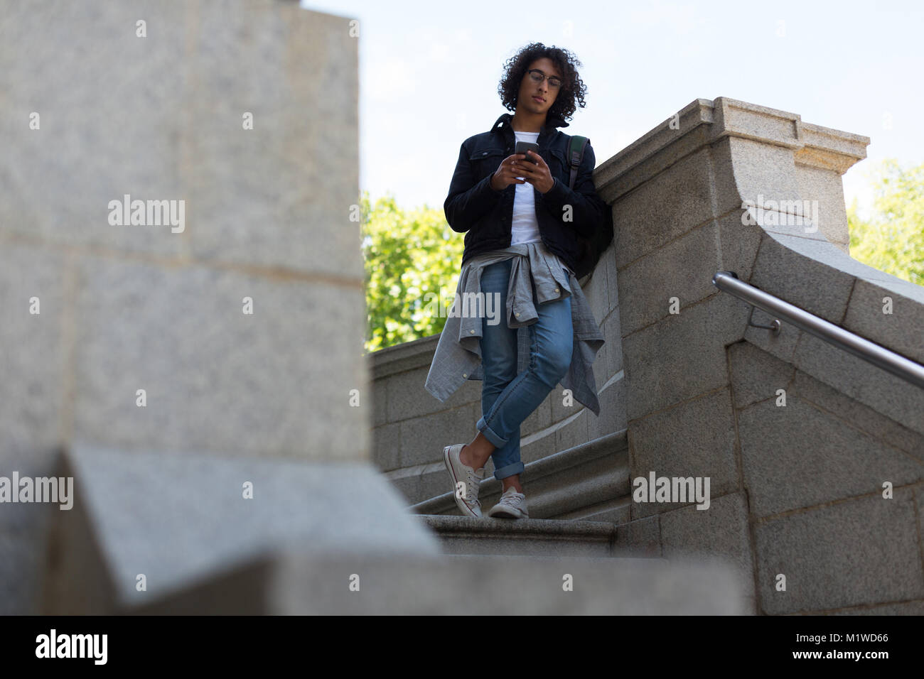 Man using mobile phone outside library building Stock Photo - Alamy