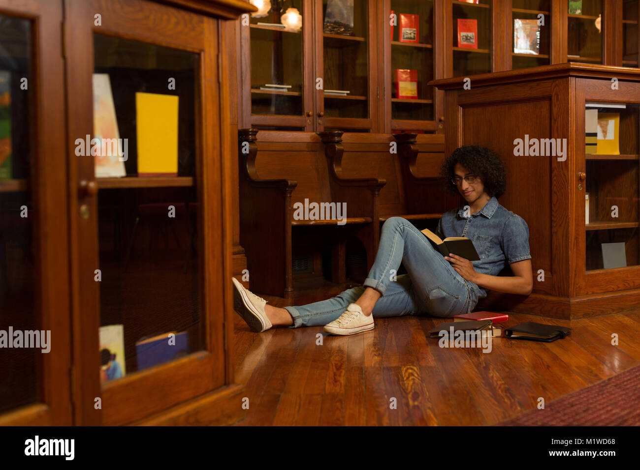 Man reading a book in library Stock Photo - Alamy