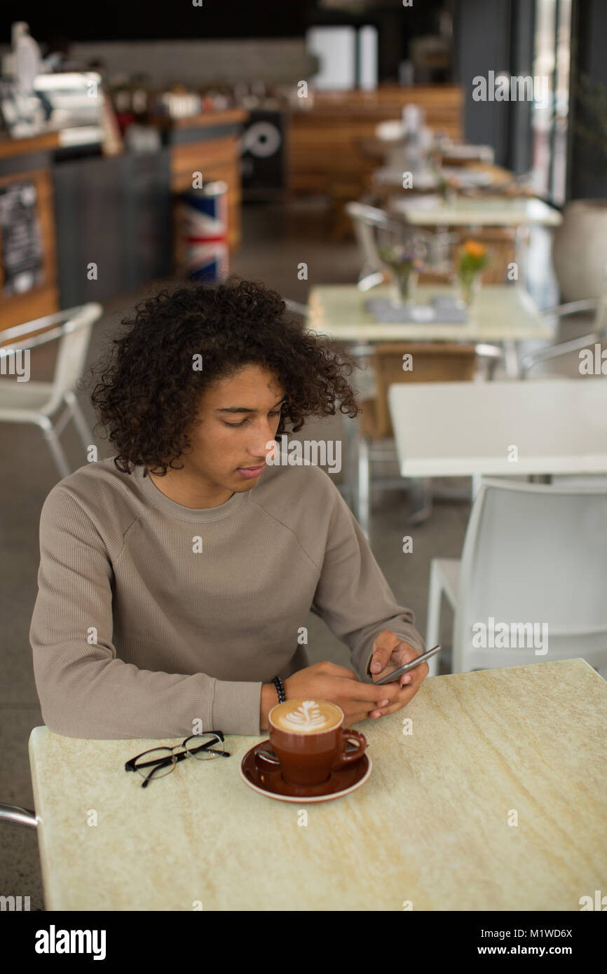 Man using mobile phone in restaurant Stock Photo - Alamy