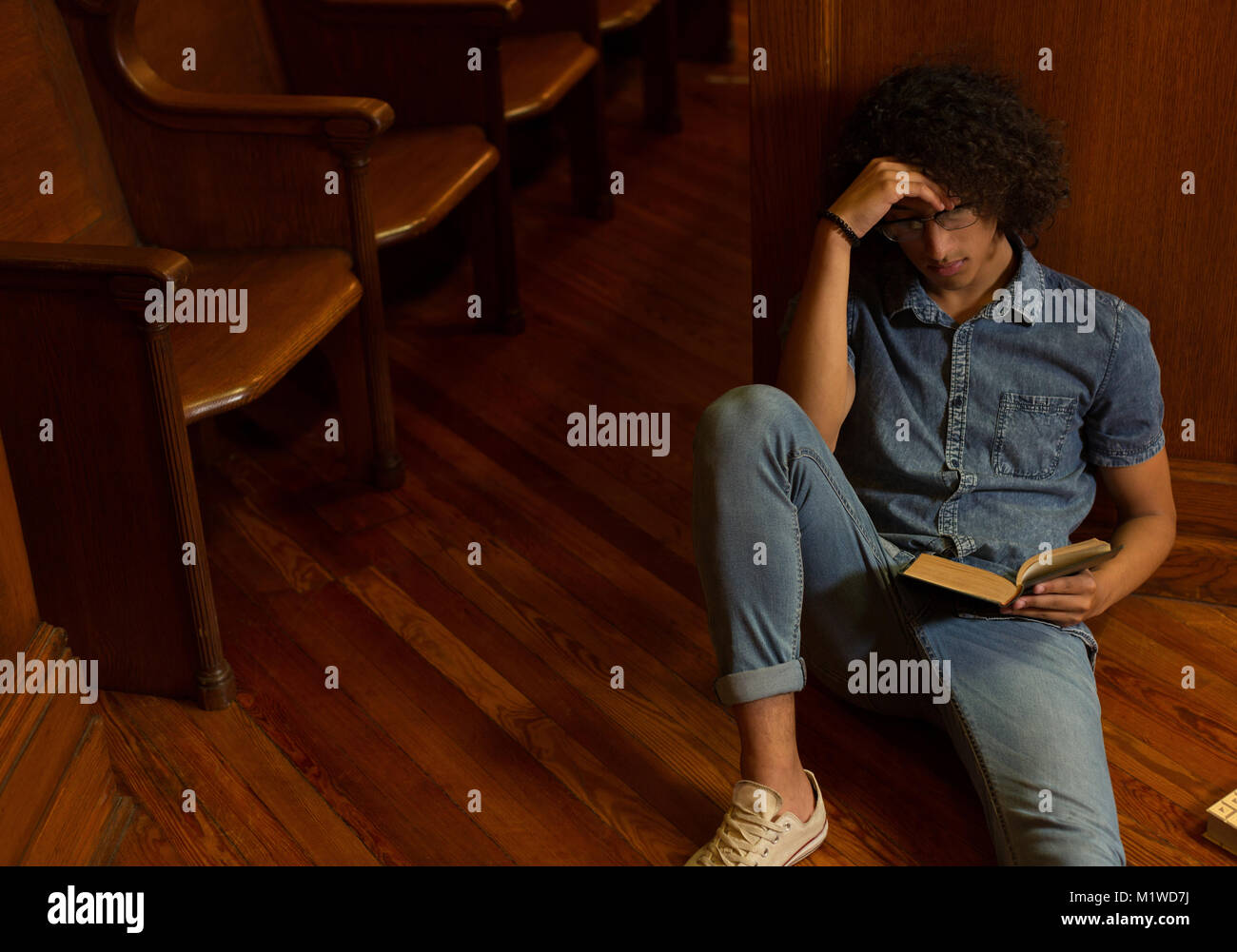 Man reading a book in library Stock Photo - Alamy