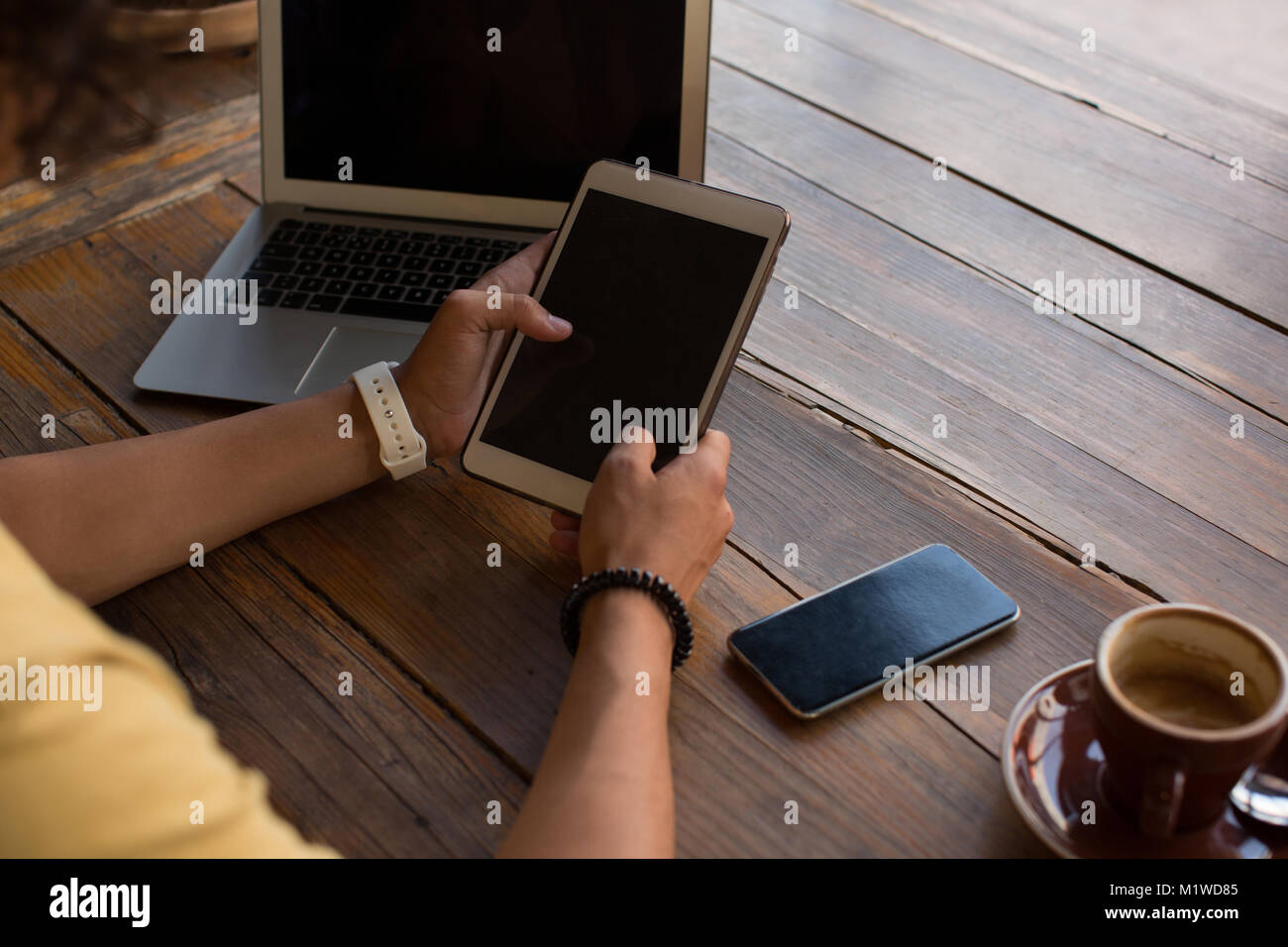 Man using digital tablet in cafeteria Stock Photo - Alamy