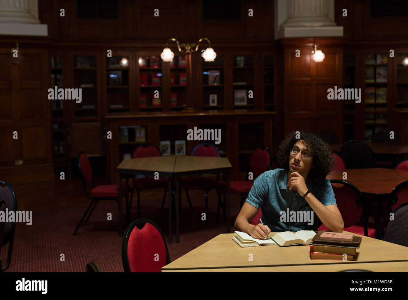 Man studying in library Stock Photo - Alamy