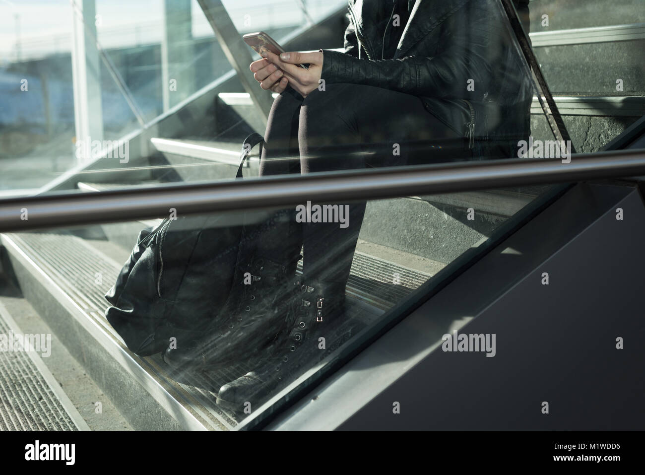 Woman using mobile phone on stairs Stock Photo - Alamy