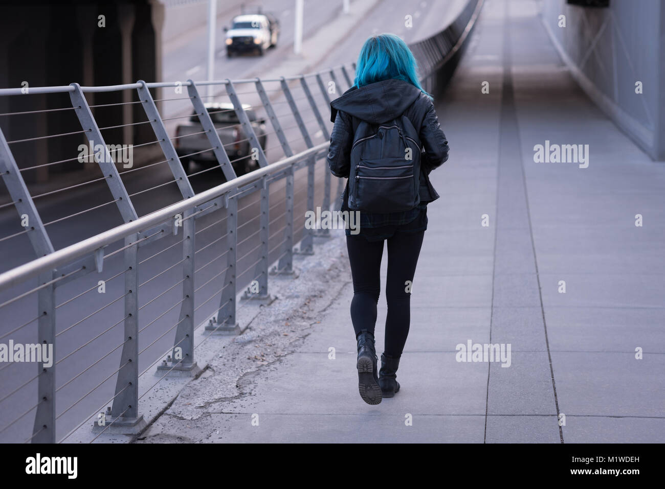 Stylish woman walking on road Stock Photo - Alamy