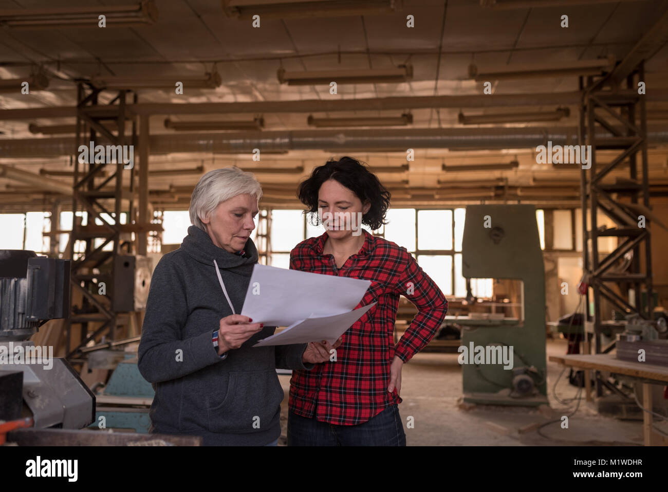 Women discussing over documents Stock Photo - Alamy