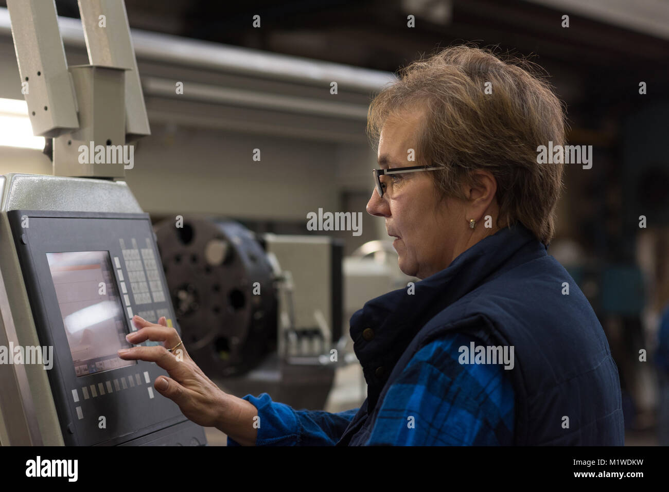 Female technician operating machine Stock Photo - Alamy Female technician operating machine Stock Photo - Alamy