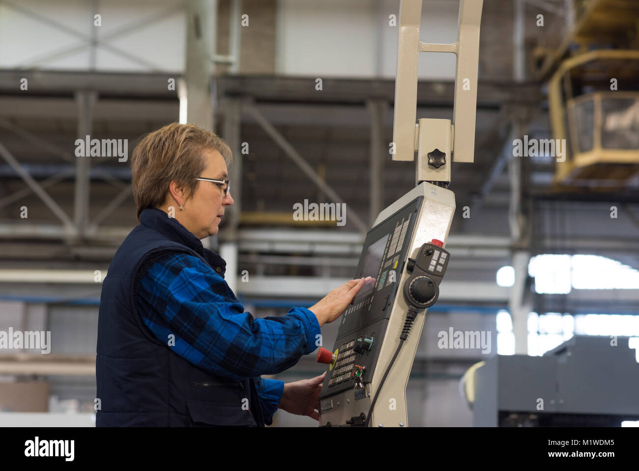 Female technician operating machine Stock Photo - Alamy