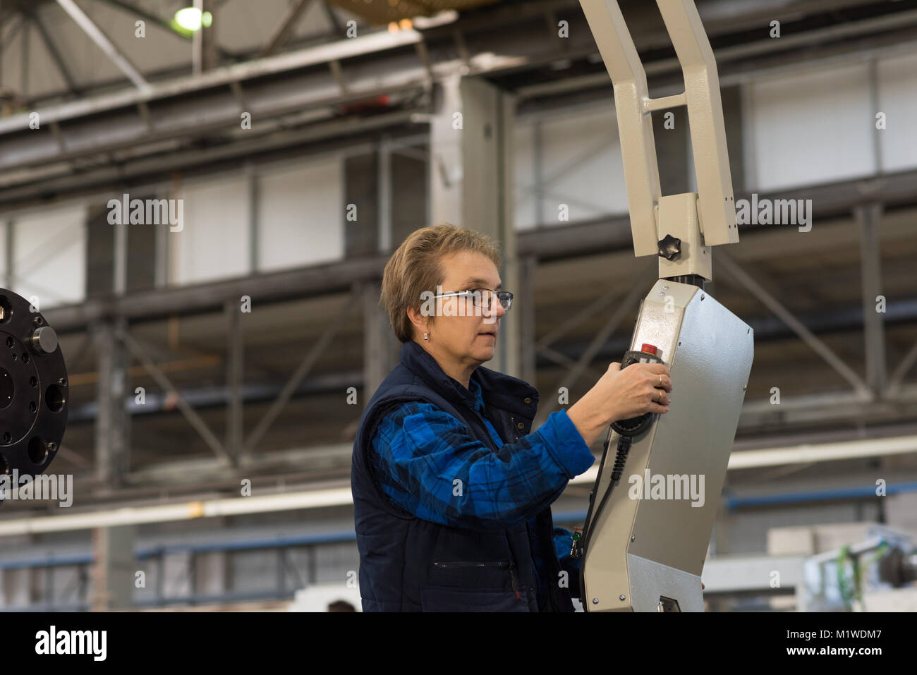 Female technician operating machine Stock Photo - Alamy