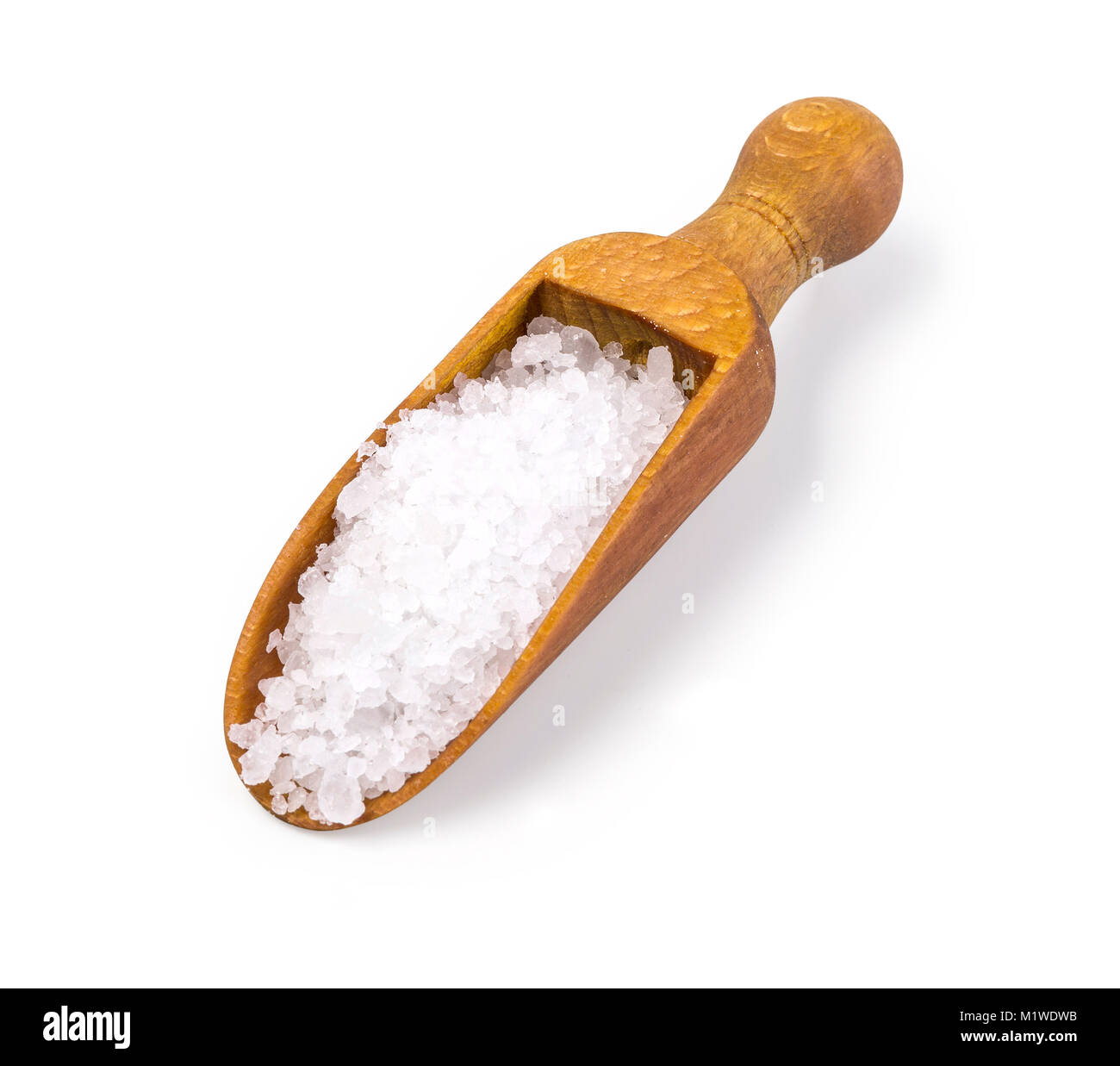 Sea salt poured from wooden scoop with clipping path Stock Photo - Alamy