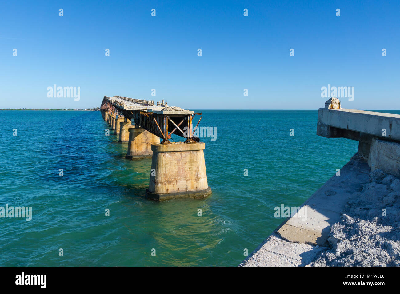 USA, Florida, Ruins of old rusty railroad bridge through the ocean ...