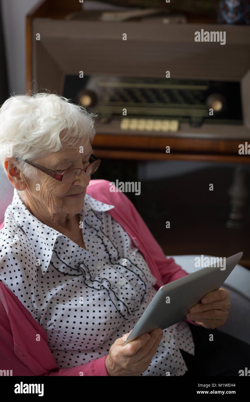Senior woman using digital tablet Stock Photo - Alamy