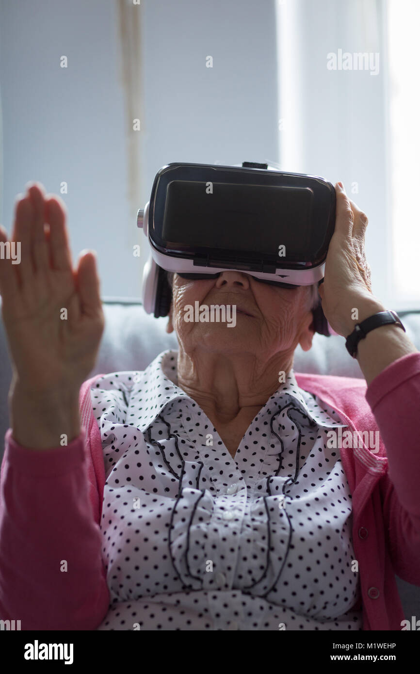 Senior woman using virtual reality headset Stock Photo - Alamy