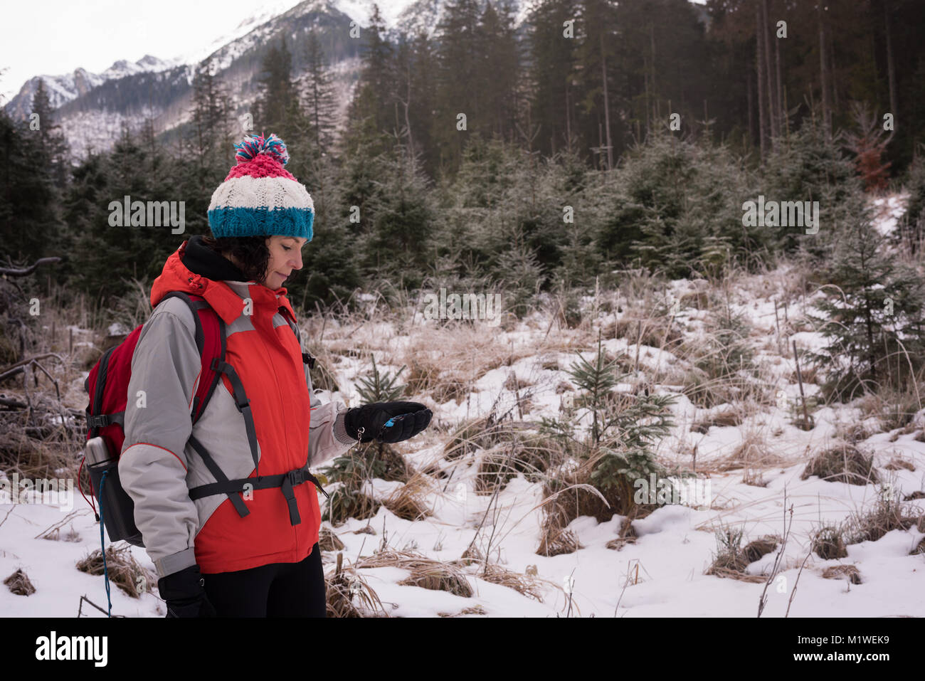 Beautiful woman looking at compass Stock Photo - Alamy