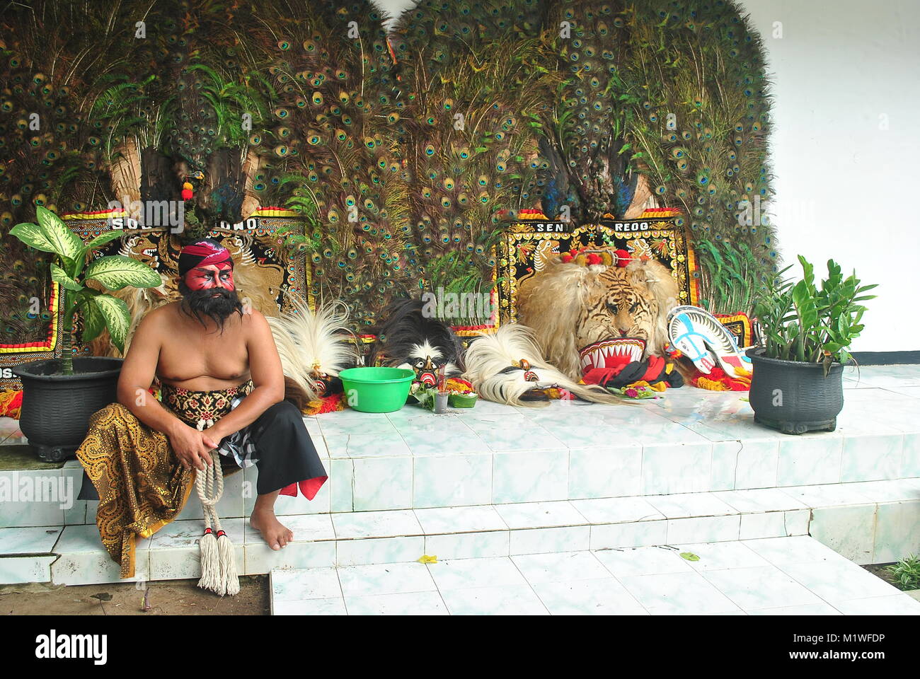 The photo depicts a dressed "Warok" in a reog ponorogo dance ...