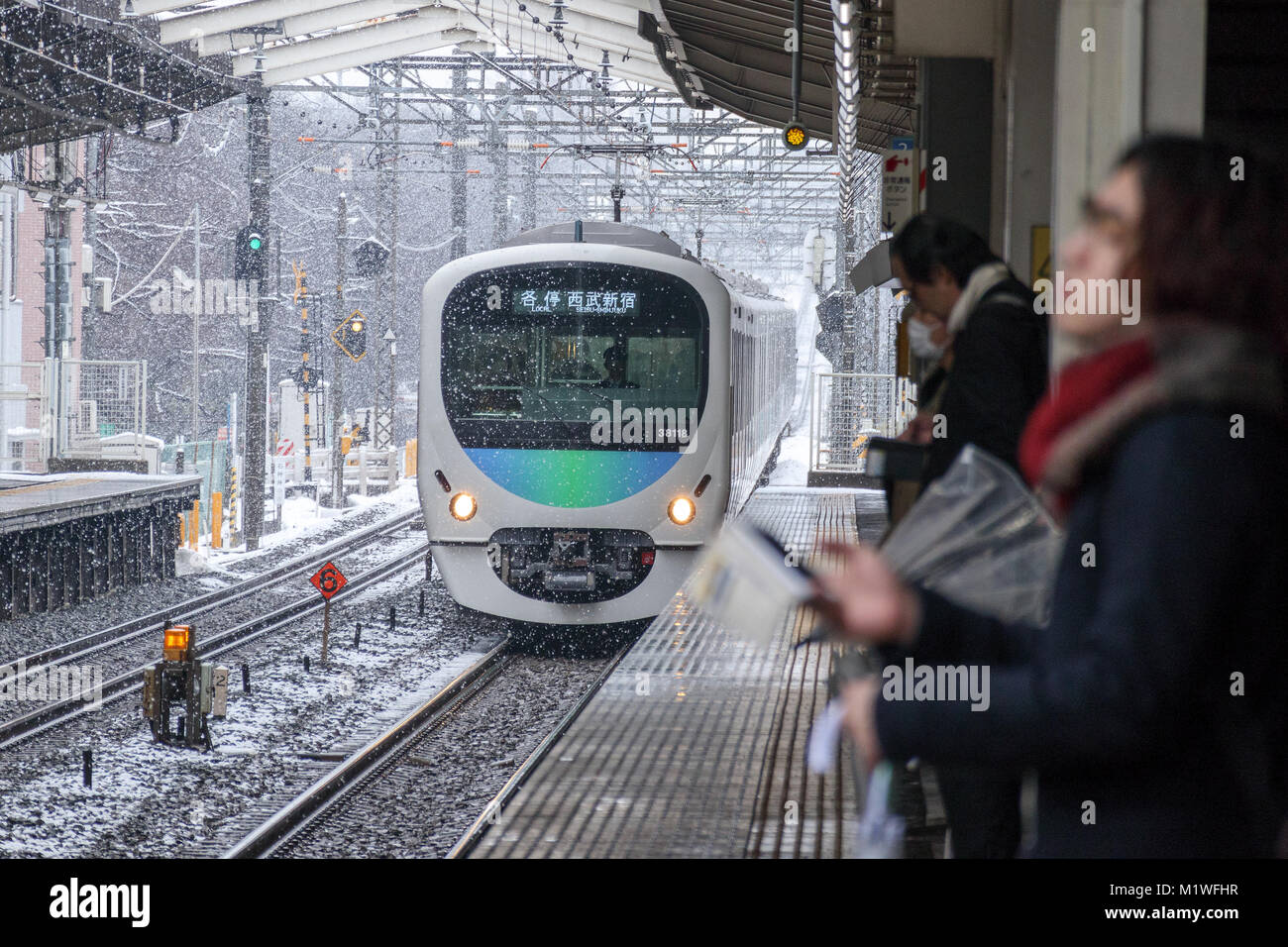 Tokyo, Japan. 2nd Feb, 2018. Passengers wait to aboard a Seibu train at ...