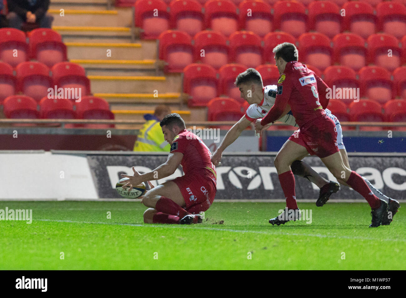 Scarlets left wing Jac Price scores the first try of the match against ...