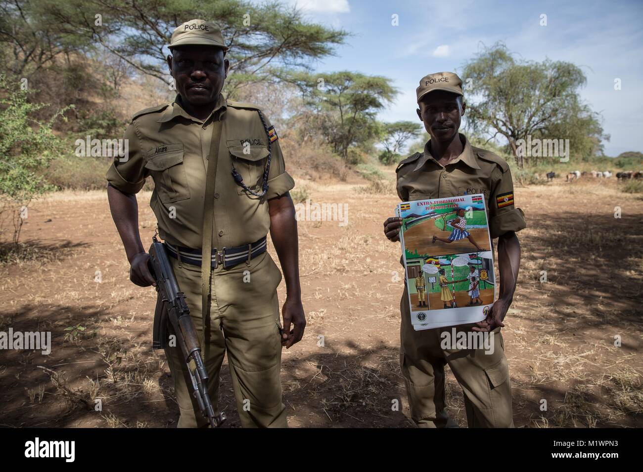 Karamoja, Uganda. 31st Jan, 2018. Ugandan police hold up a poster ...