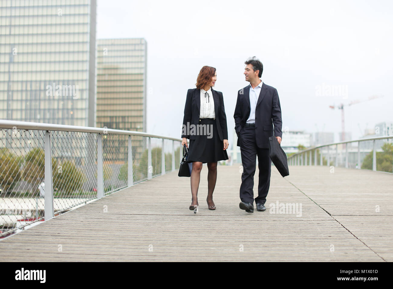 economists male and female in strict suits walking Stock Photo - Alamy
