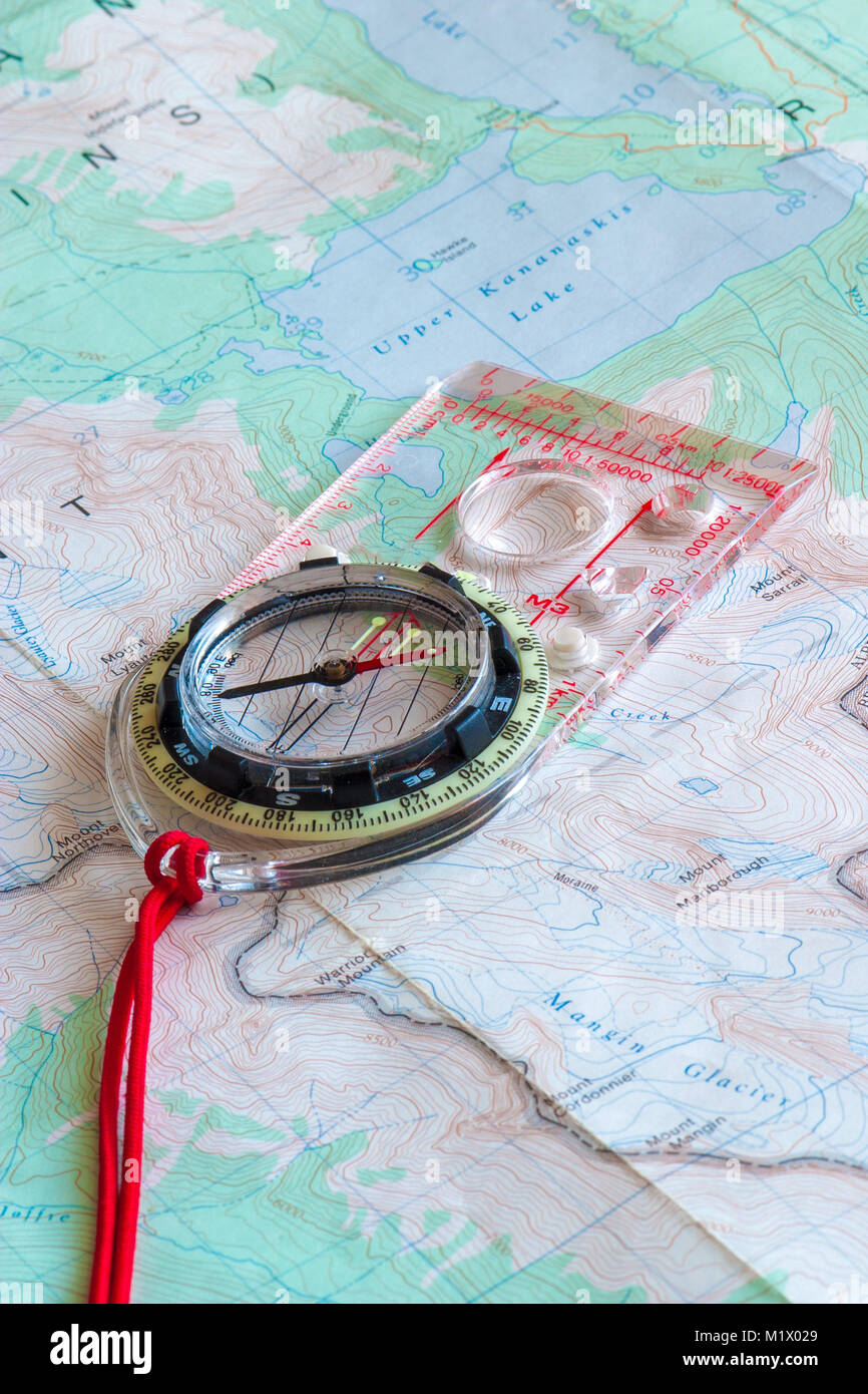 Compass on top of a topographic map Stock Photo - Alamy