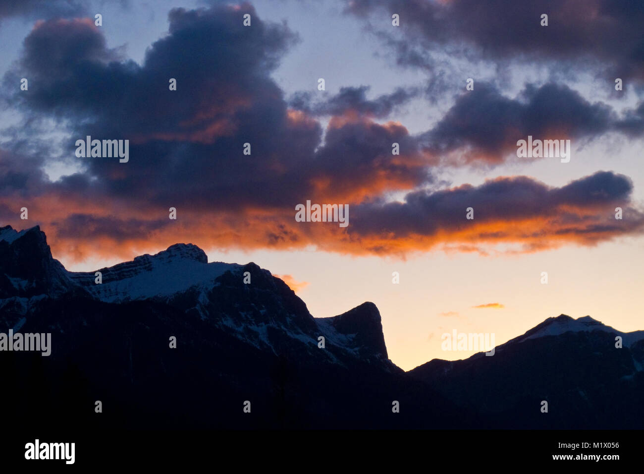 Silhouetted mountains orange sunset clouds, Canmore, Alberta, Canada ...