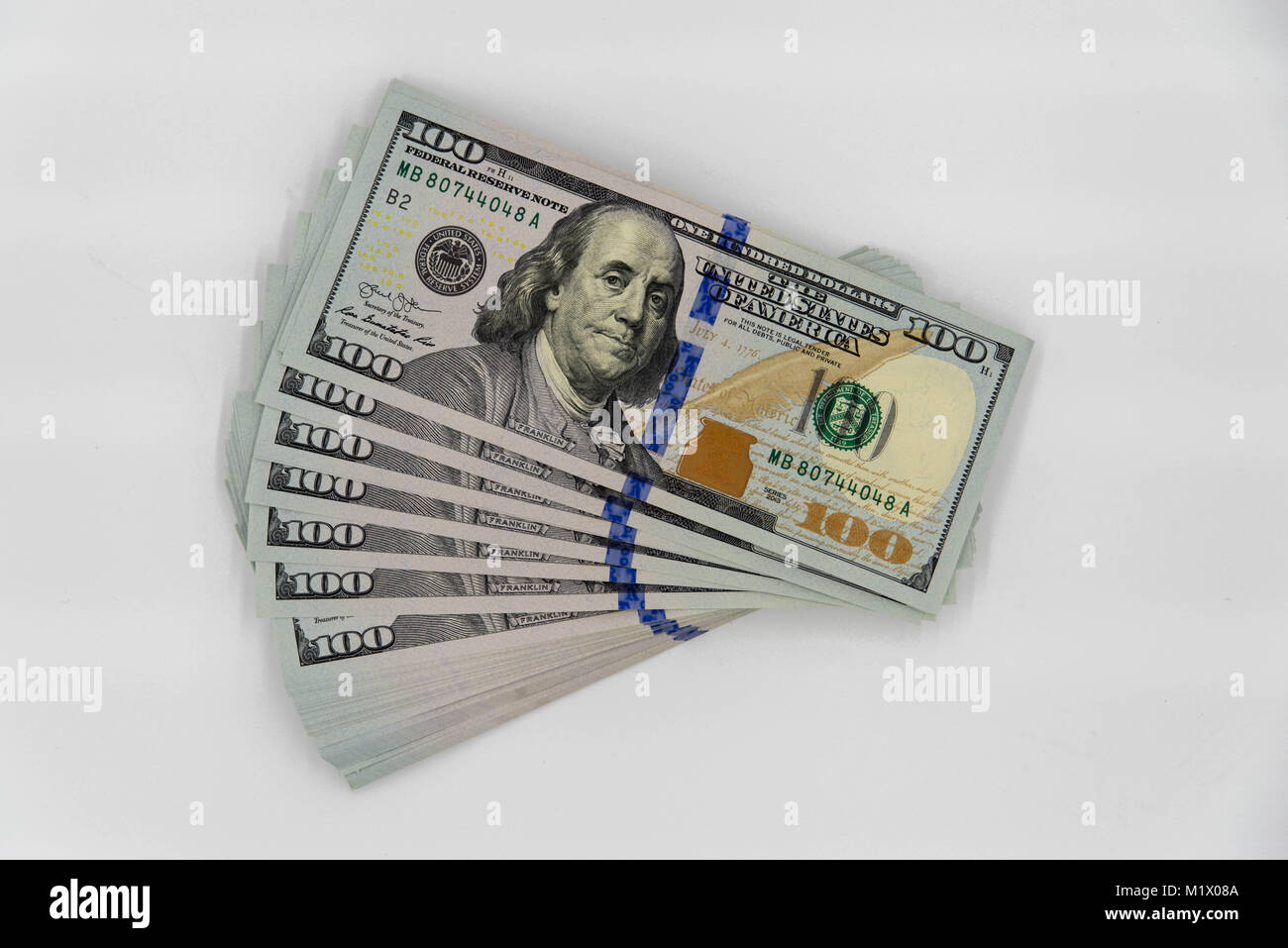 a stack of us 100 dollars cash with white background Stock Photo - Alamy