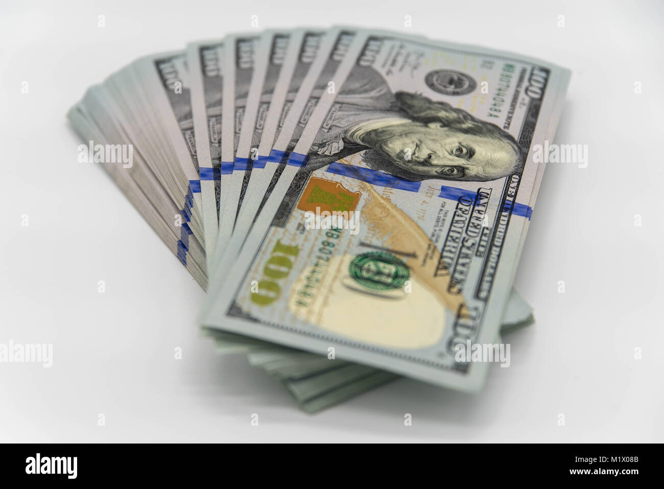 a stack of us 100 dollars cash with white background Stock Photo - Alamy