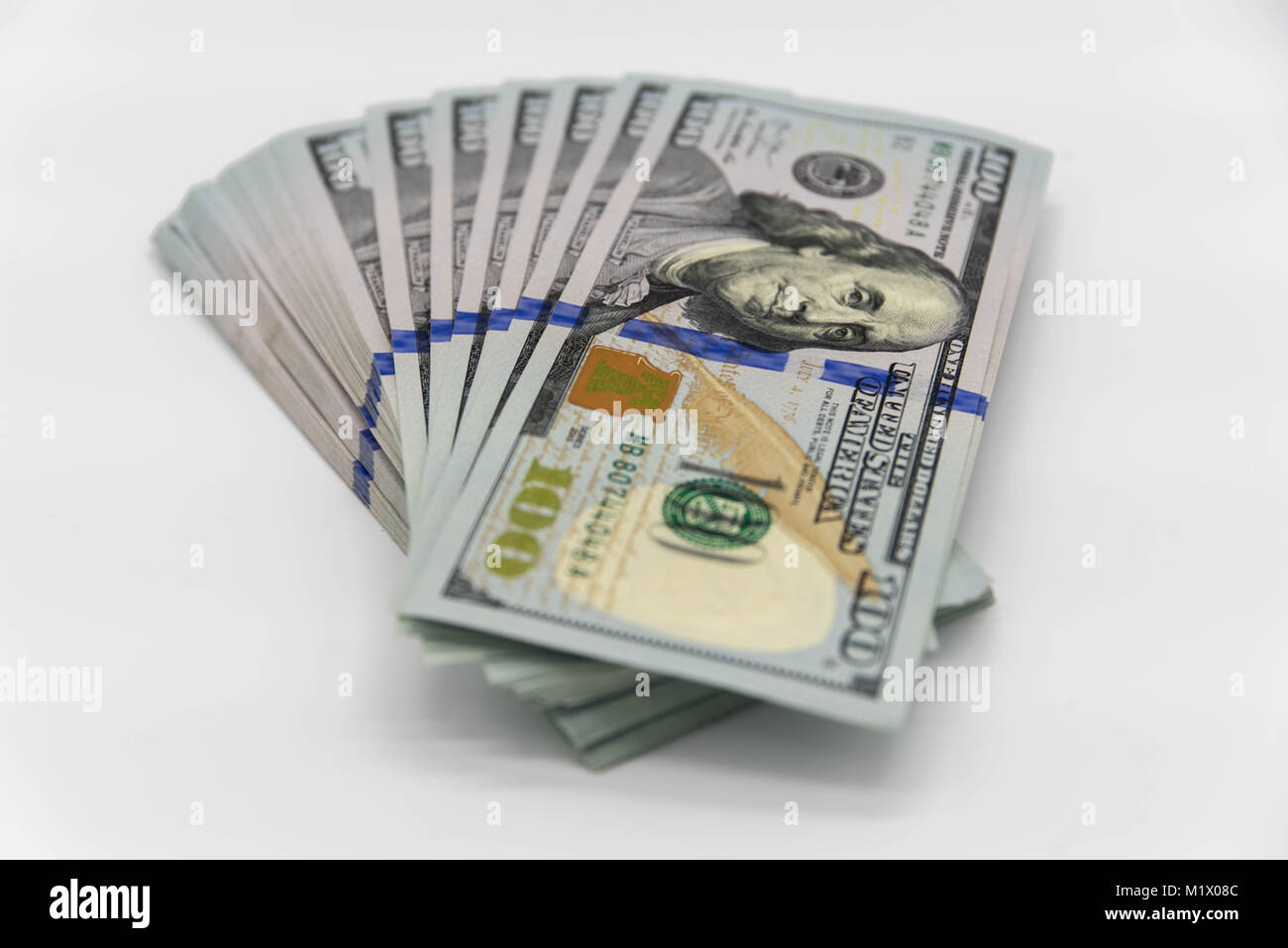 a stack of us 100 dollars cash with white background Stock Photo - Alamy