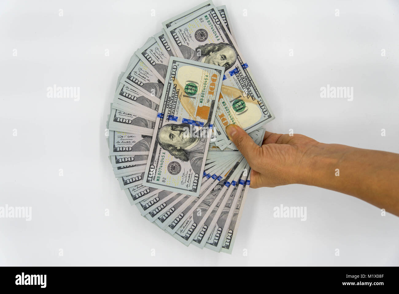 Pick up 100 us dollar white background Stock Photo - Alamy